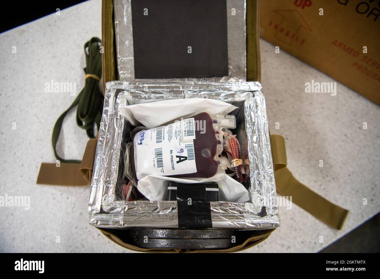 A thermal blood transport box containing four packs of blood is ...