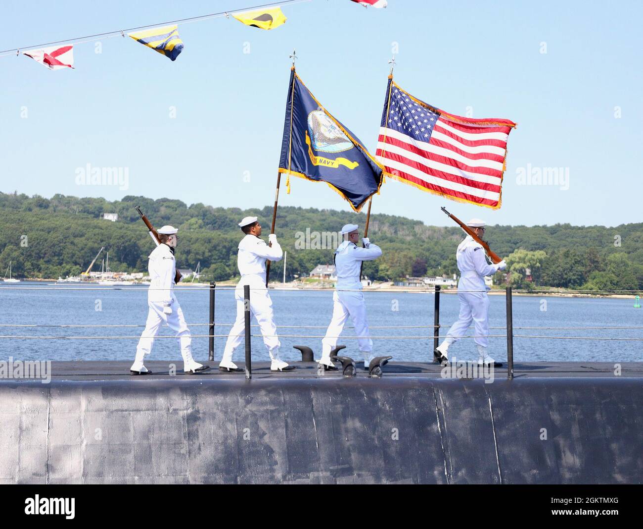 A color guard stands marches off from atop the former USS Nautilus (SSN ...