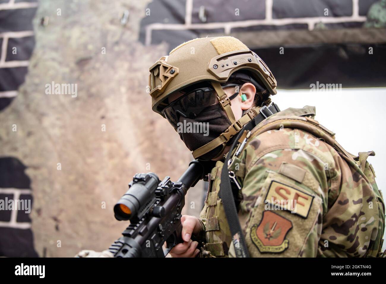 An Airman from the 422nd Security Forces Squadron, scans her perimeter ...