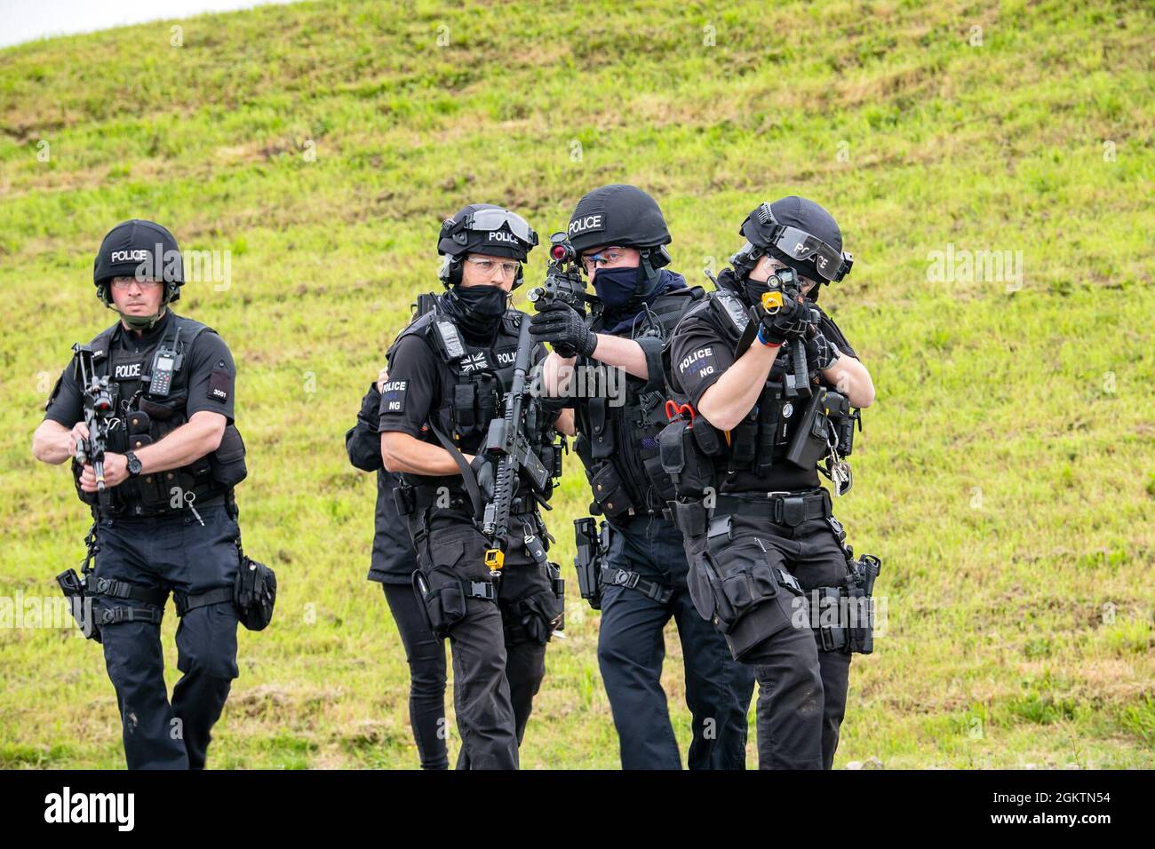 Police officers from the Northamptonshire Police Department advance ...