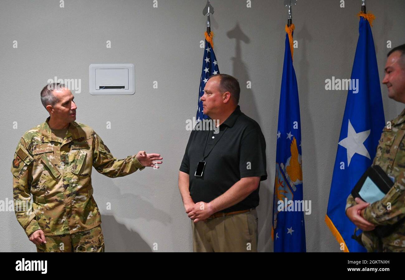Maj. Gen. Jeffrey Pennington, 4th Air Force commander, presents a coin ...