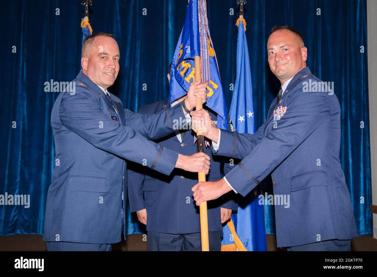 Col. Paul Toth, 90th Medical Group commander, passes the guidon to Lt ...