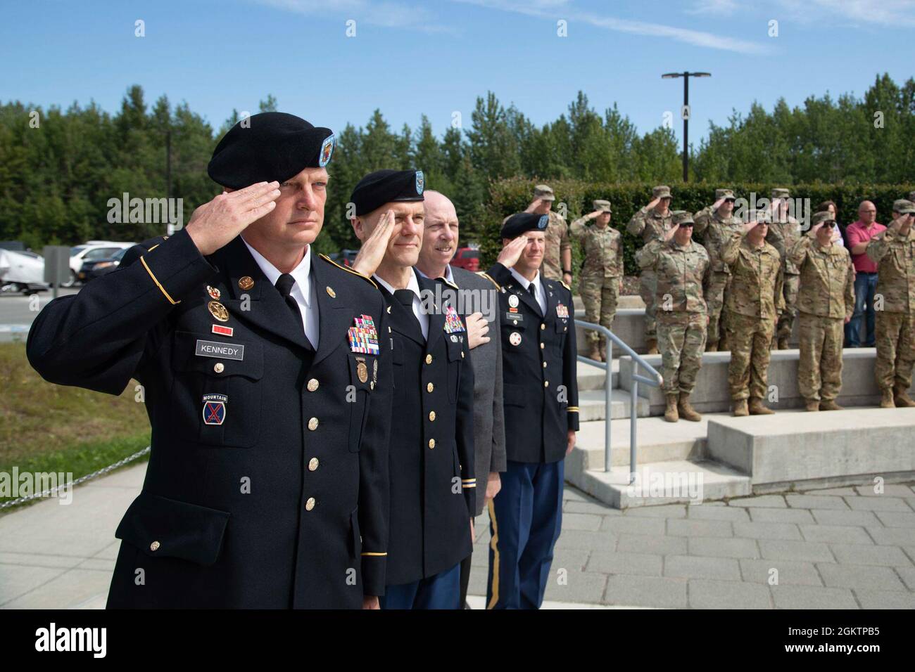 Sgt. Major Andrew Kennedy, front, salutes during the National Anthem at ...