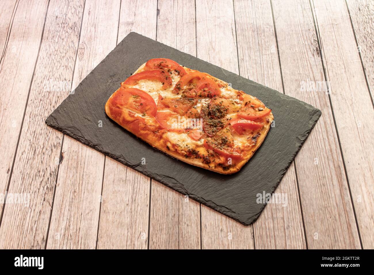 Small individual pizza with mozzarella, lots of tomato and spices from ...