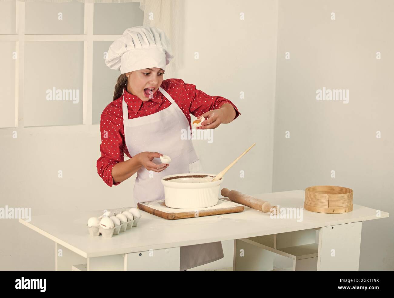 surprised child prepares dough in kitchen, surprise Stock Photo - Alamy