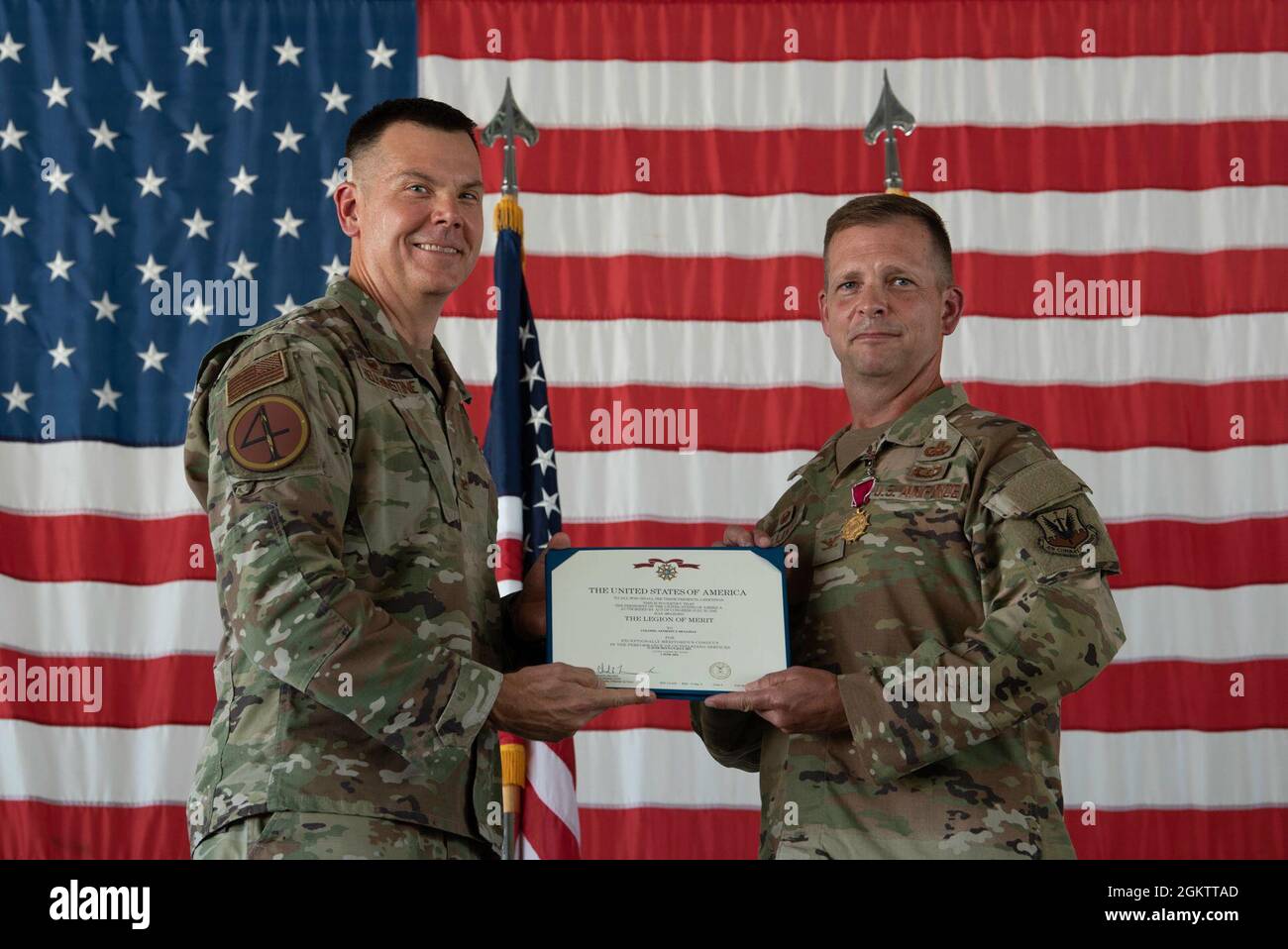 Col. Anthony Mullinax, outgoing 4th Mission Group commander, receives ...