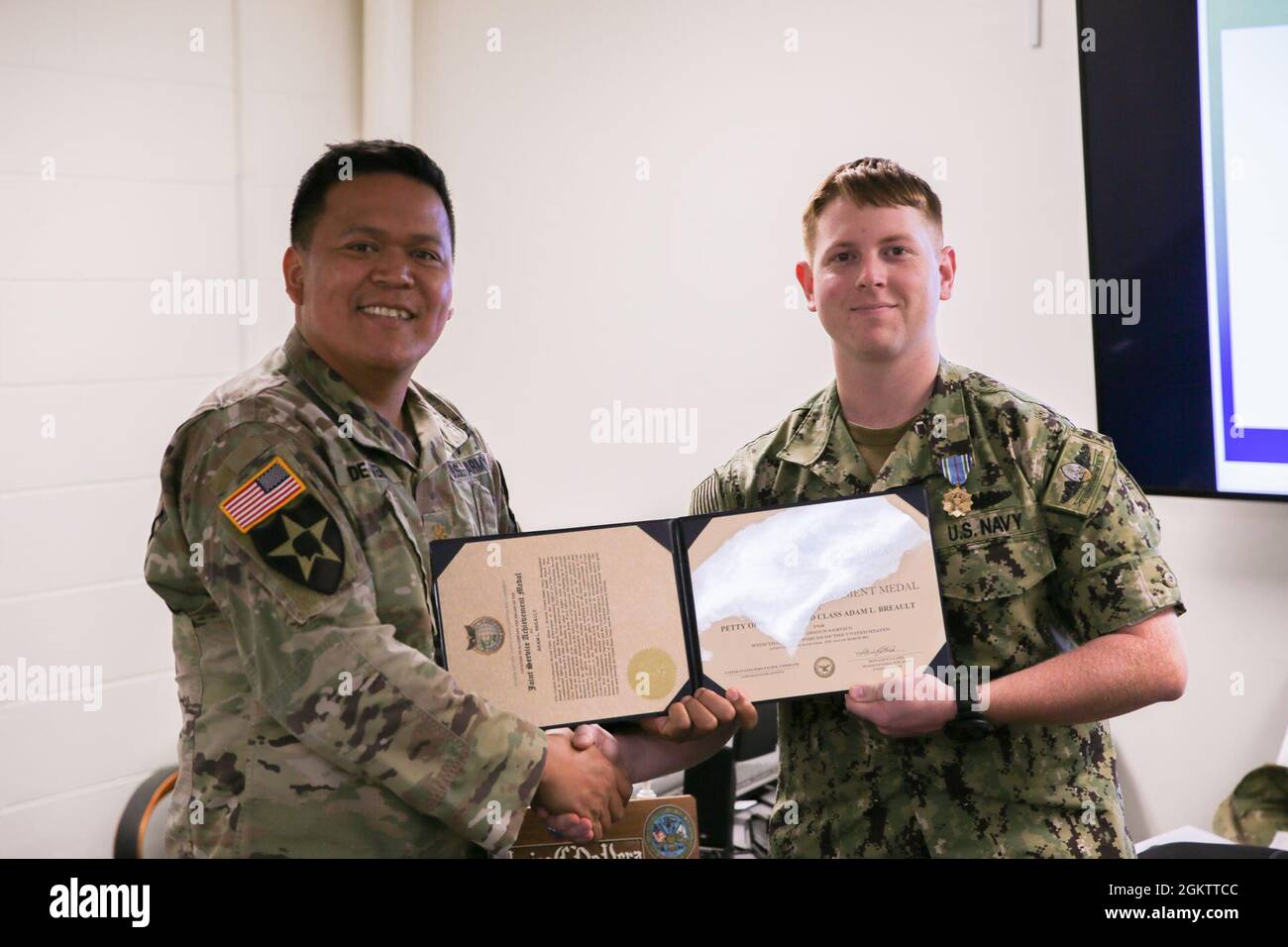 U.S. Navy Petty Officer 2nd Class Adam L. Breault receives the Joint ...