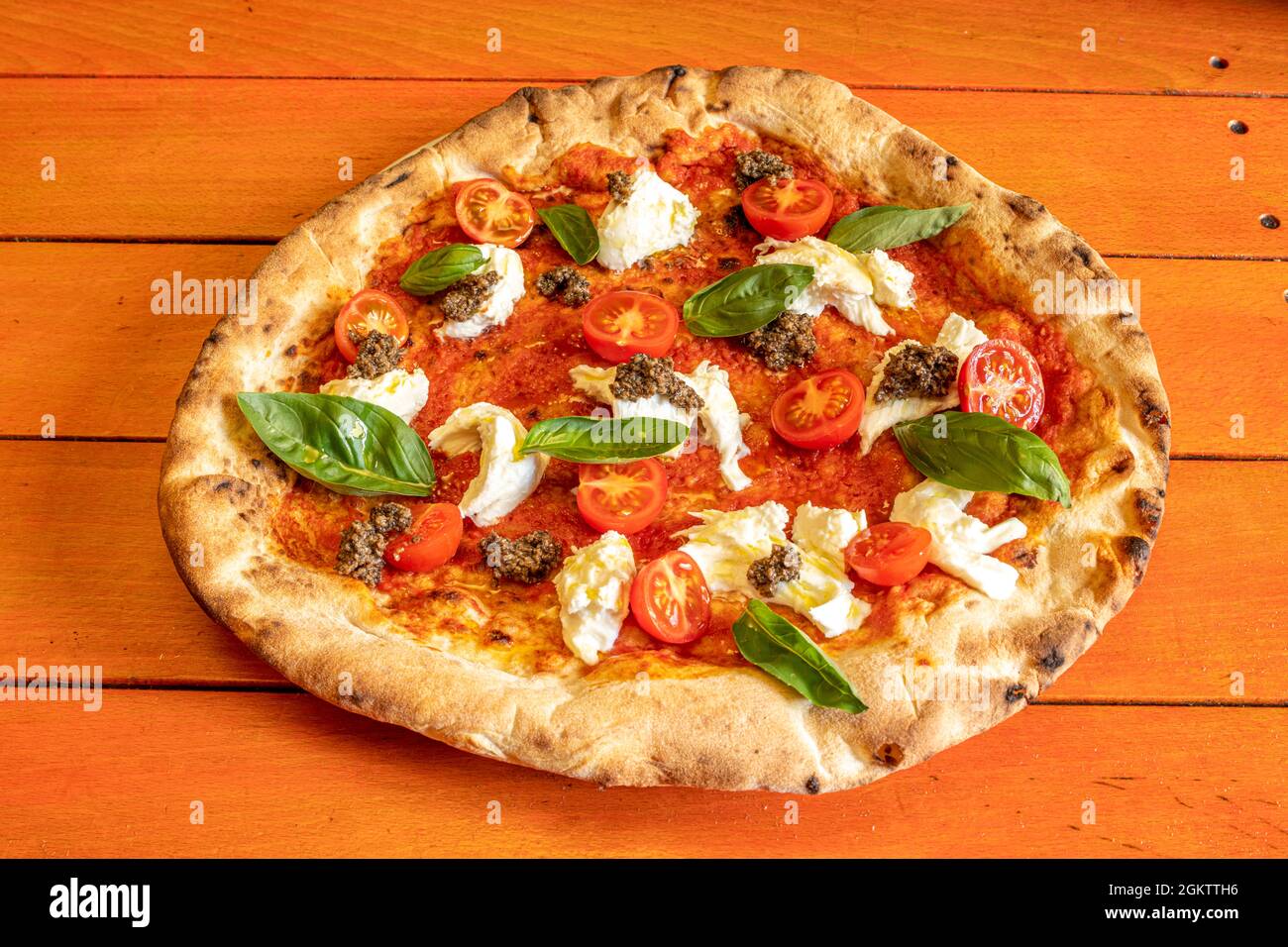 Italian sponge crust pizza with pieces of bufala cheese, cherry ...