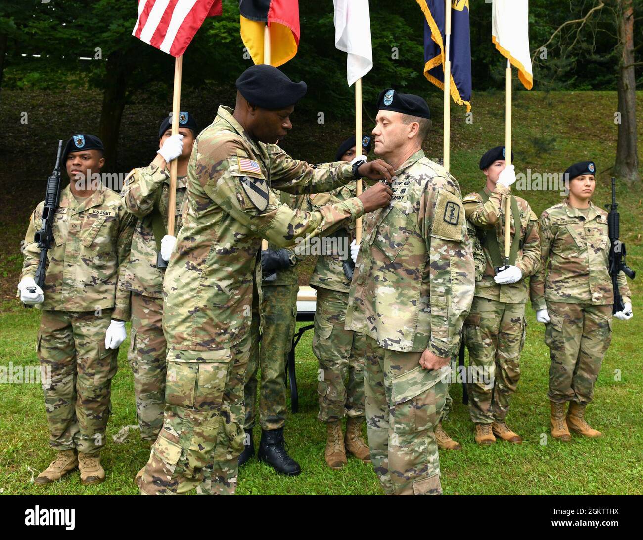 U.S. Army Brig. Gen. James M. Smith, commander, 21st Theater Sustainment Command pins the Legion ...