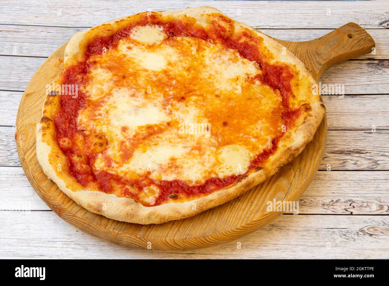 Italian five-cheese pizza with tomato and thin wheat dough on wooden ...