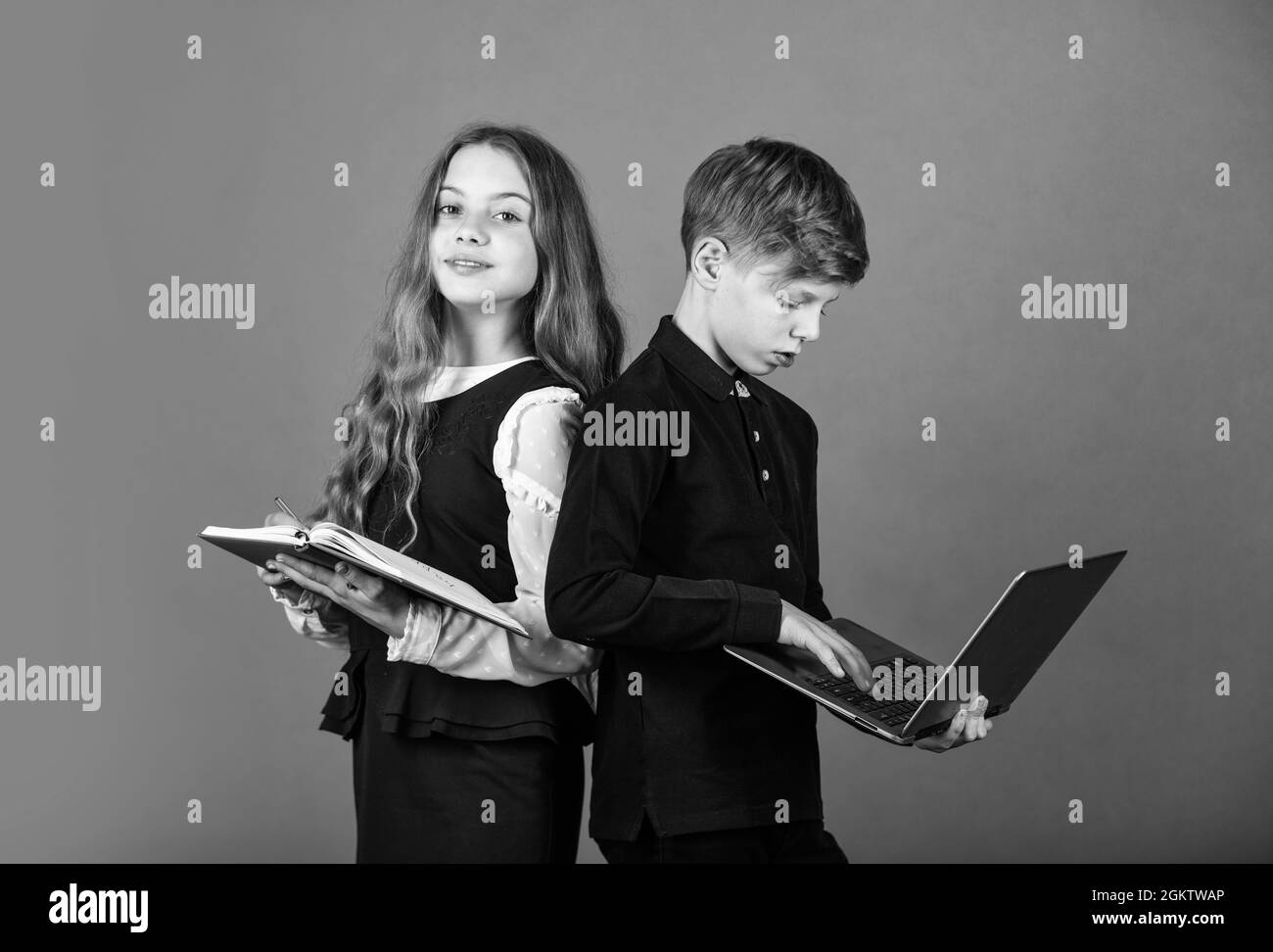 Create future. Little children use IT book and computer. Small girl and ...