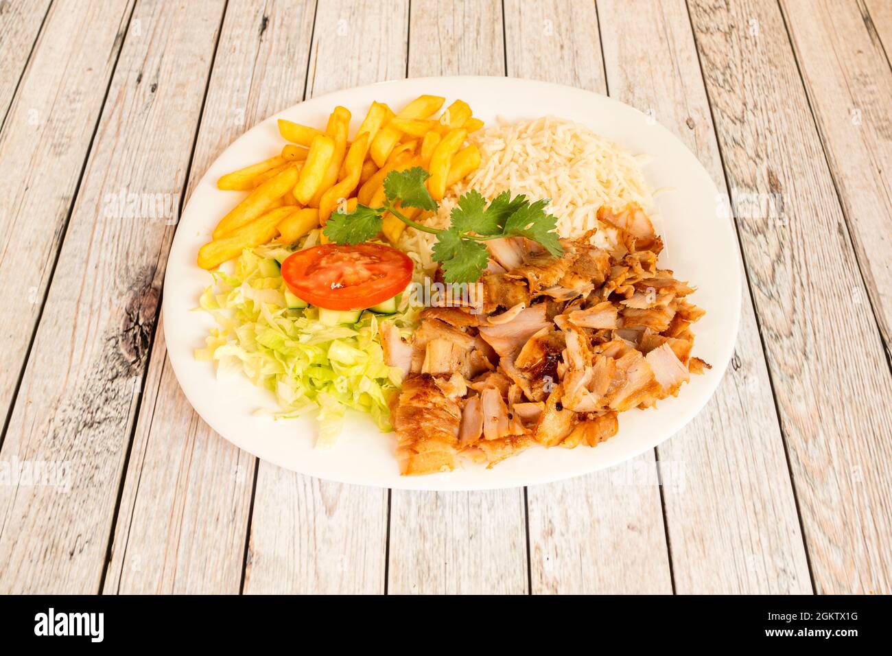 Kebab menu with grilled chicken meat garnished with fried potatoes ...