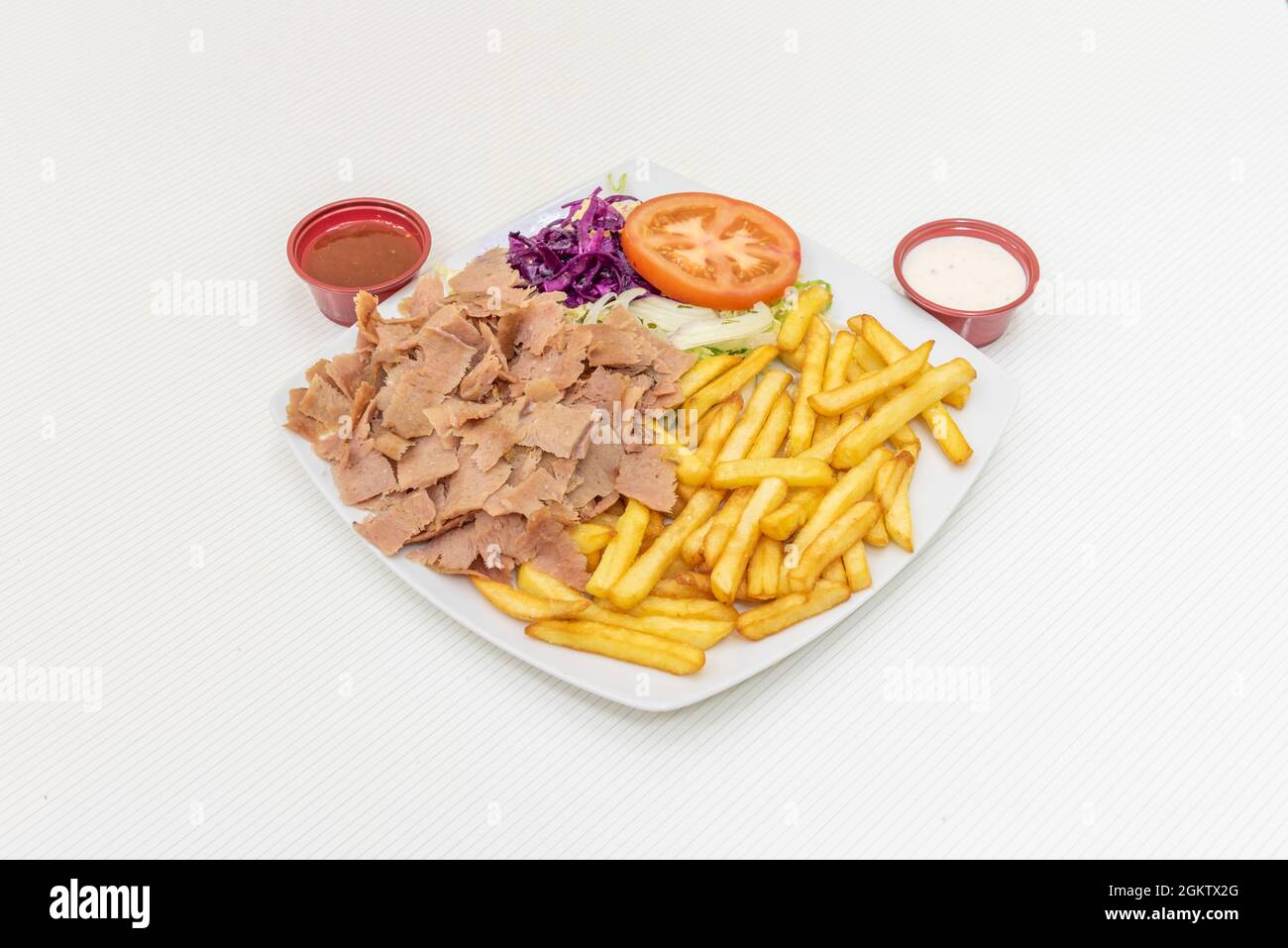 Menu lamb kebab plate with fried potatoes, chopped meat, purple cabbage ...