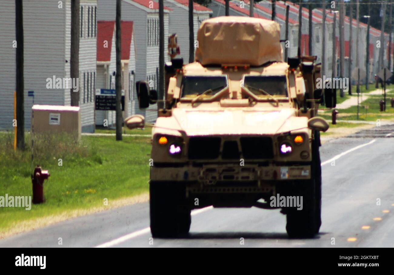 Personnel drive a Joint Light Tactical Vehicle (JLTV) through the ...