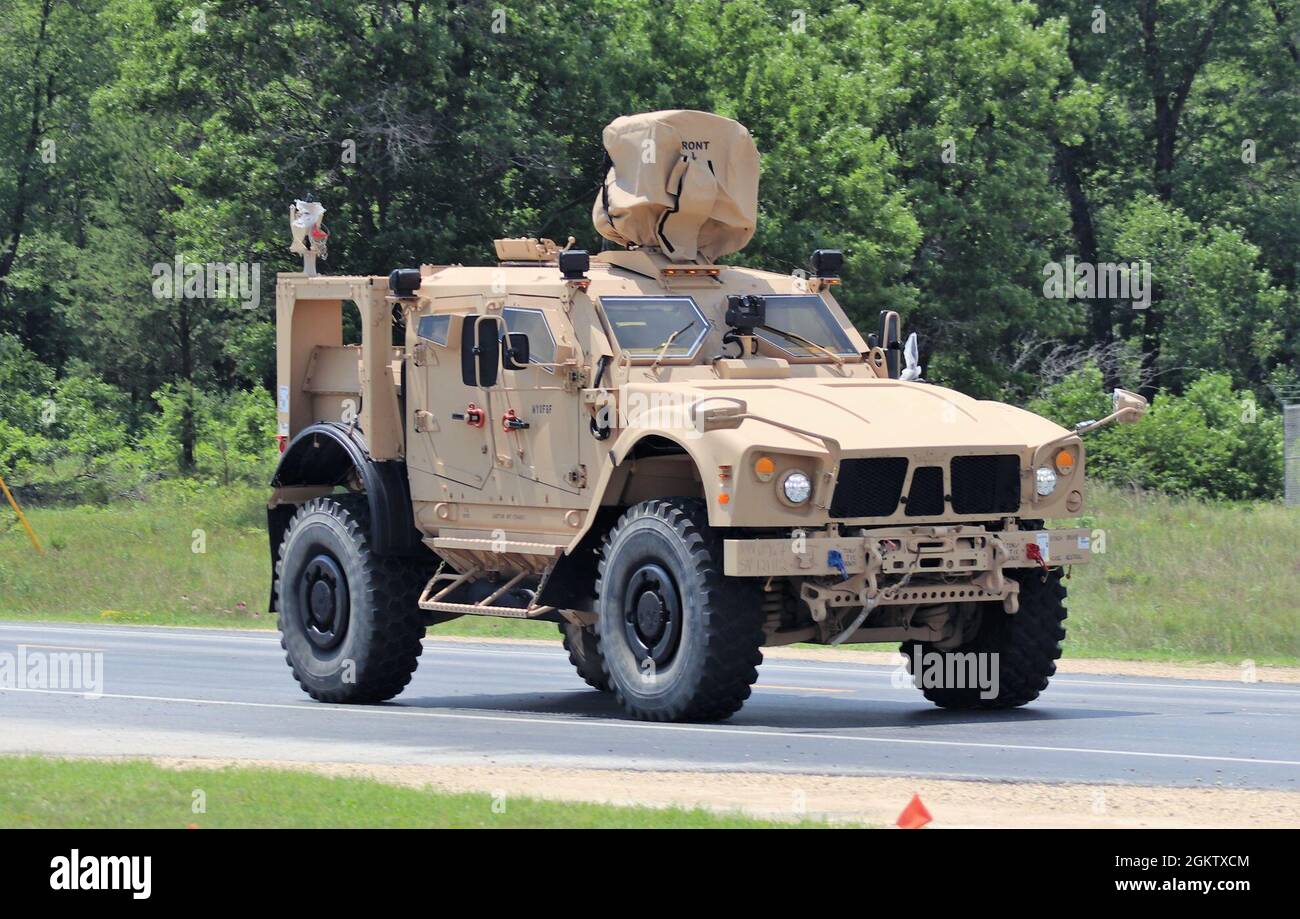 Personnel drive a Joint Light Tactical Vehicle (JLTV) through the ...
