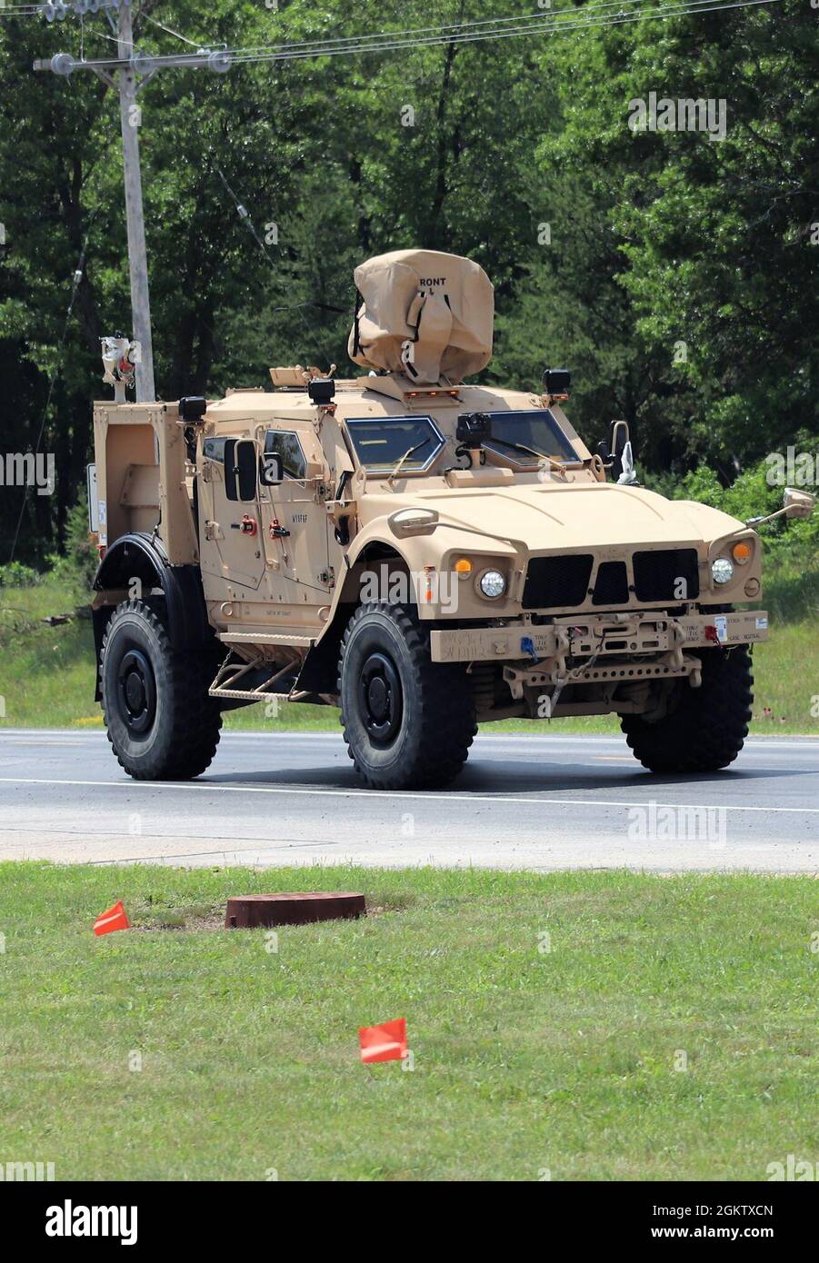 Personnel drive a Joint Light Tactical Vehicle (JLTV) through the ...