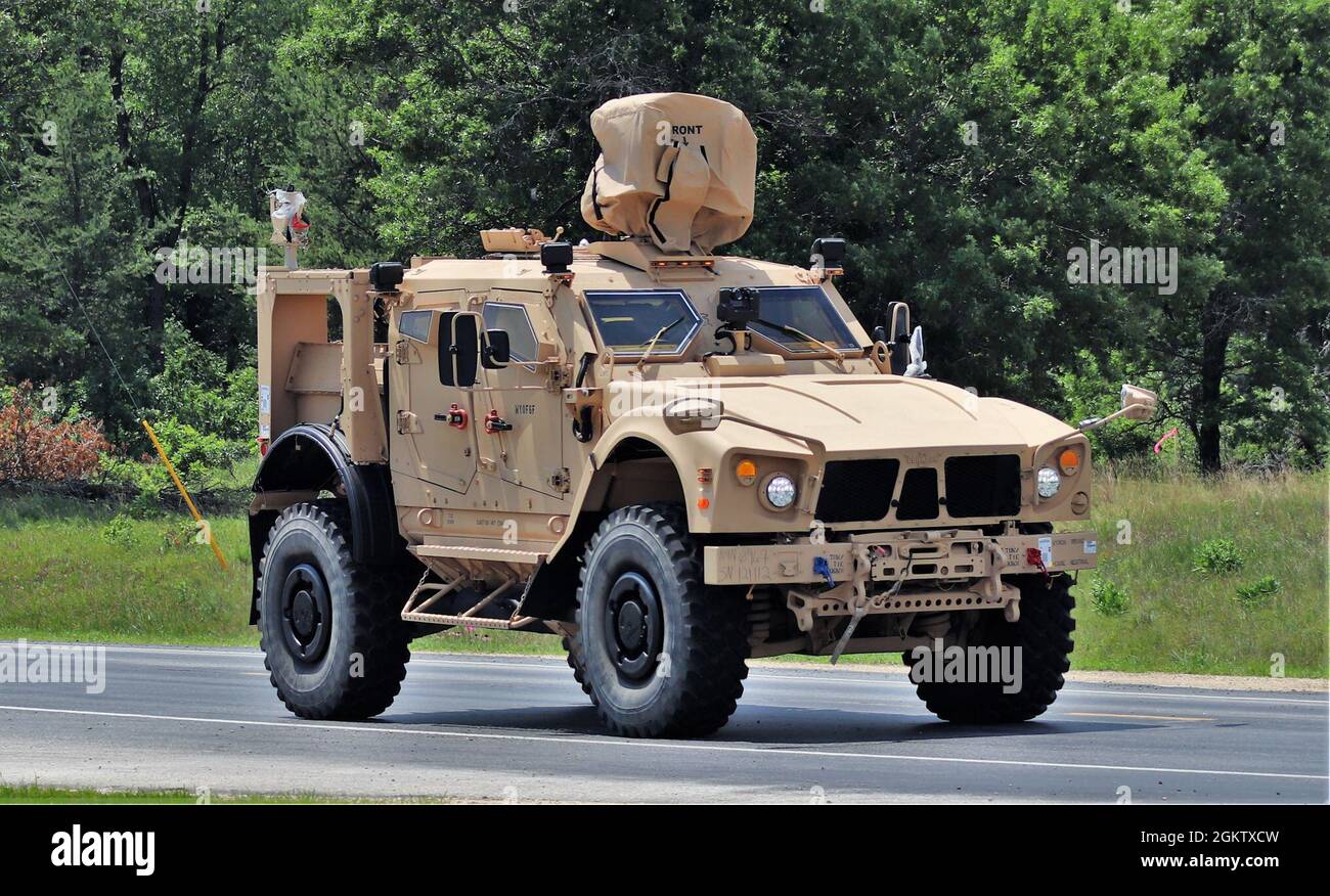 Personnel drive a Joint Light Tactical Vehicle (JLTV) through the ...