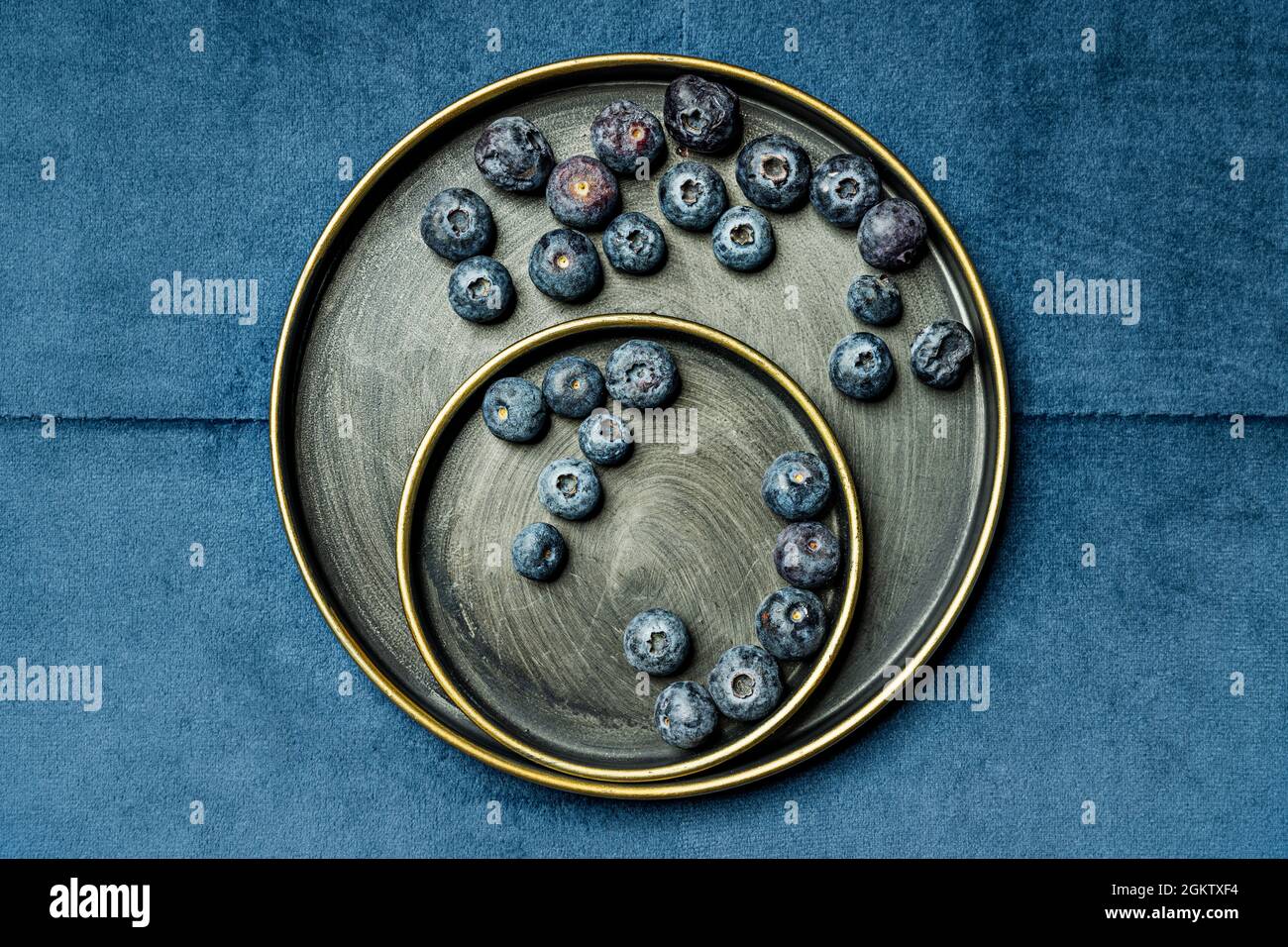 Top view of metal vintage plates one inside the other with a handful of ...