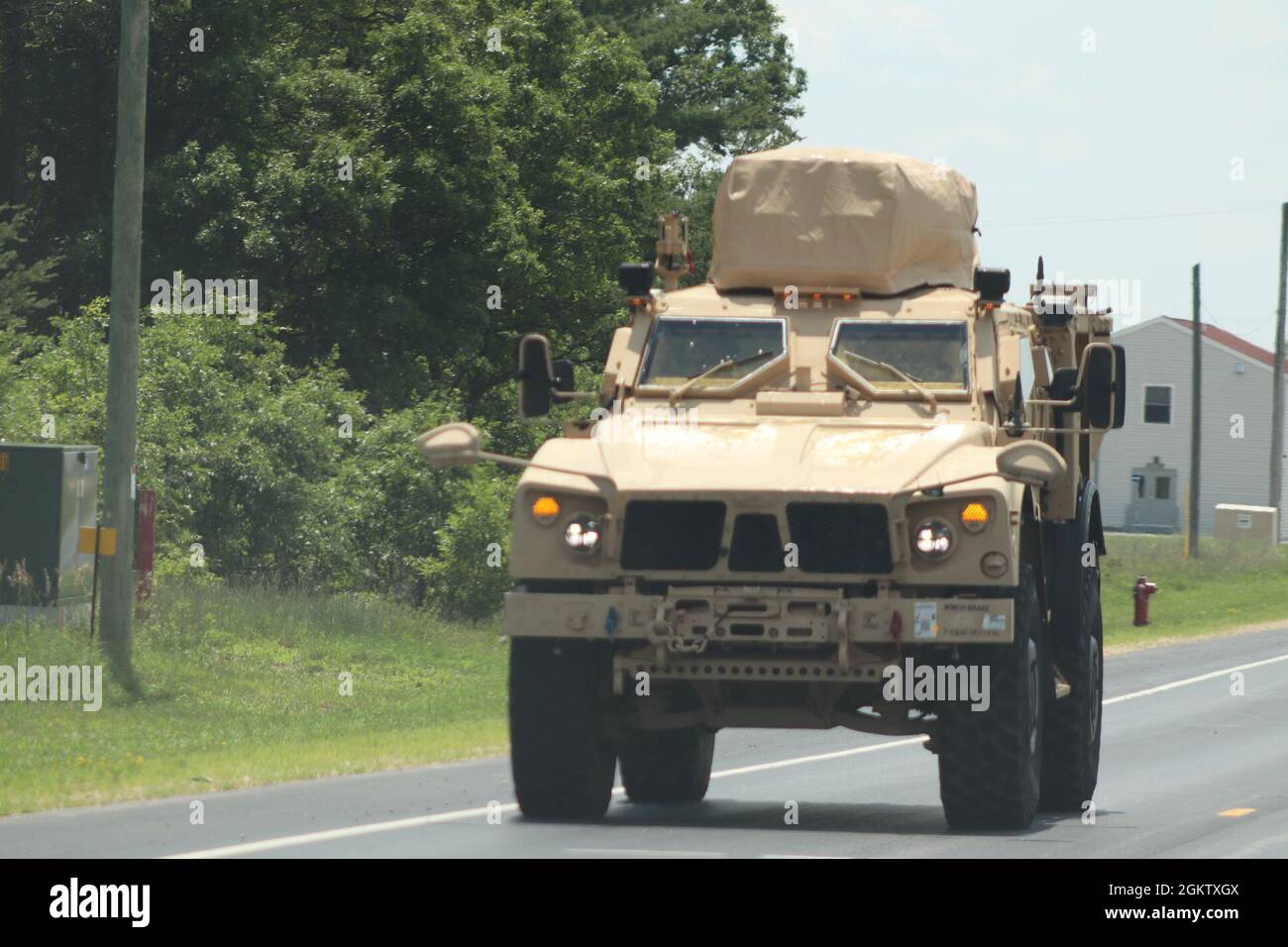 Personnel drive a Joint Light Tactical Vehicle (JLTV) through the ...