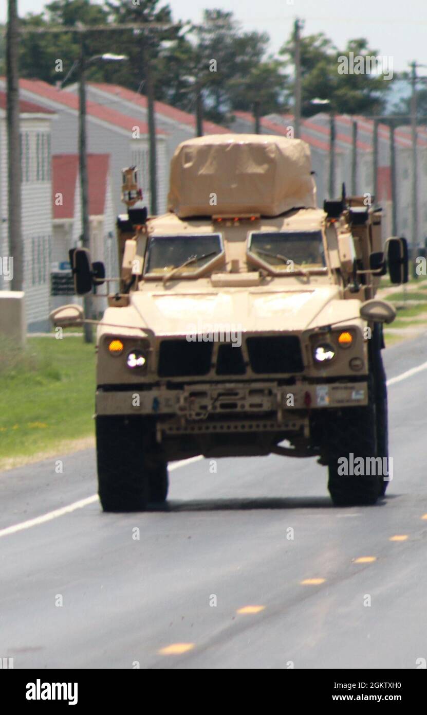 Personnel drive a Joint Light Tactical Vehicle (JLTV) through the ...