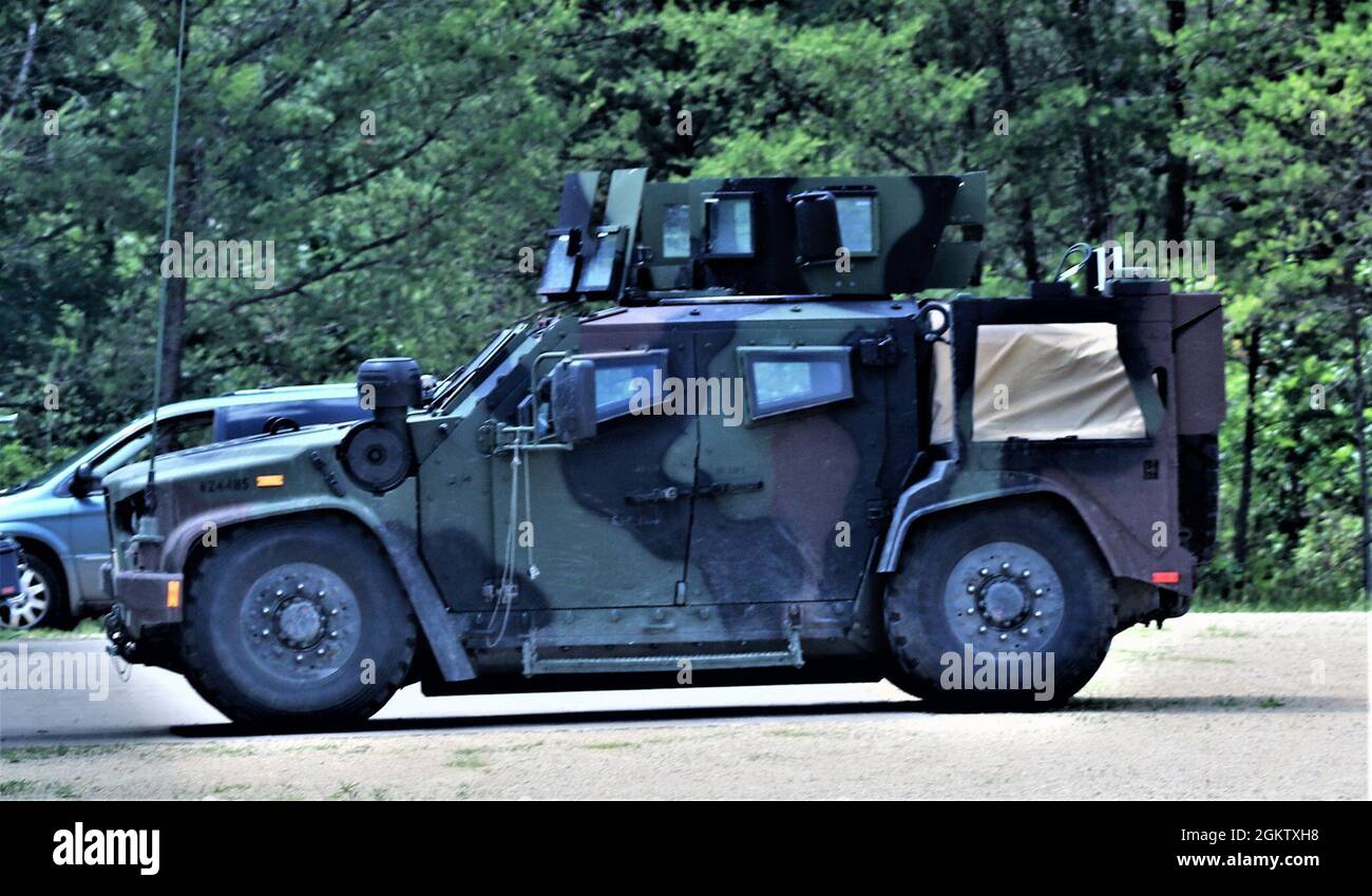 Personnel drive a Joint Light Tactical Vehicle (JLTV) through the ...