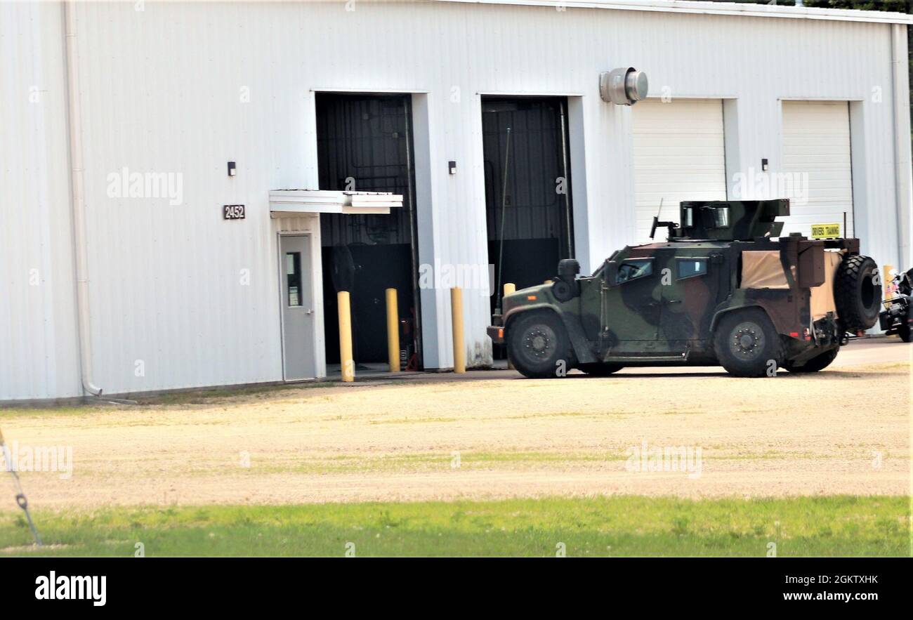 Personnel drive a Joint Light Tactical Vehicle (JLTV) through the ...