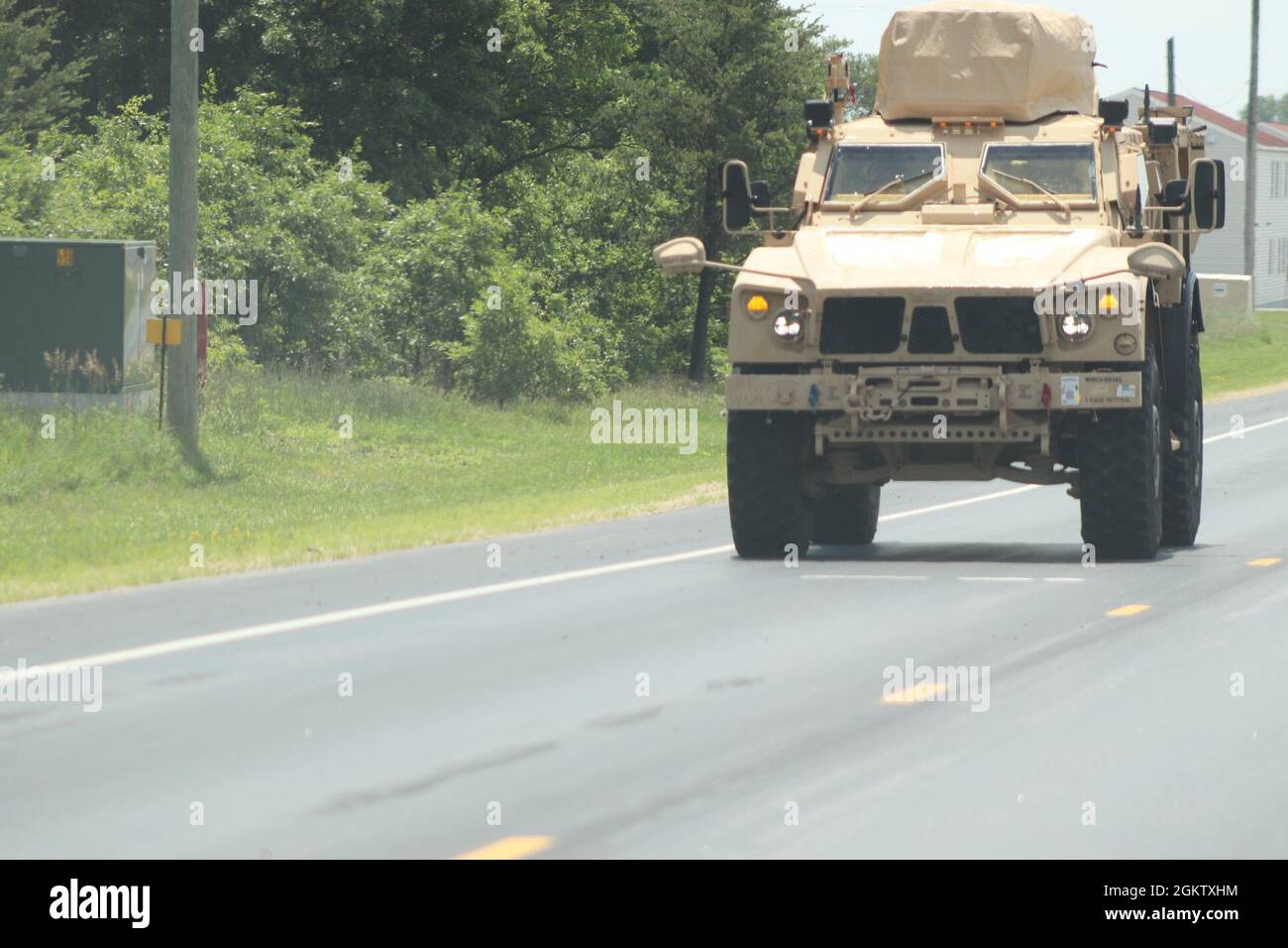 Personnel drive a Joint Light Tactical Vehicle (JLTV) through the ...