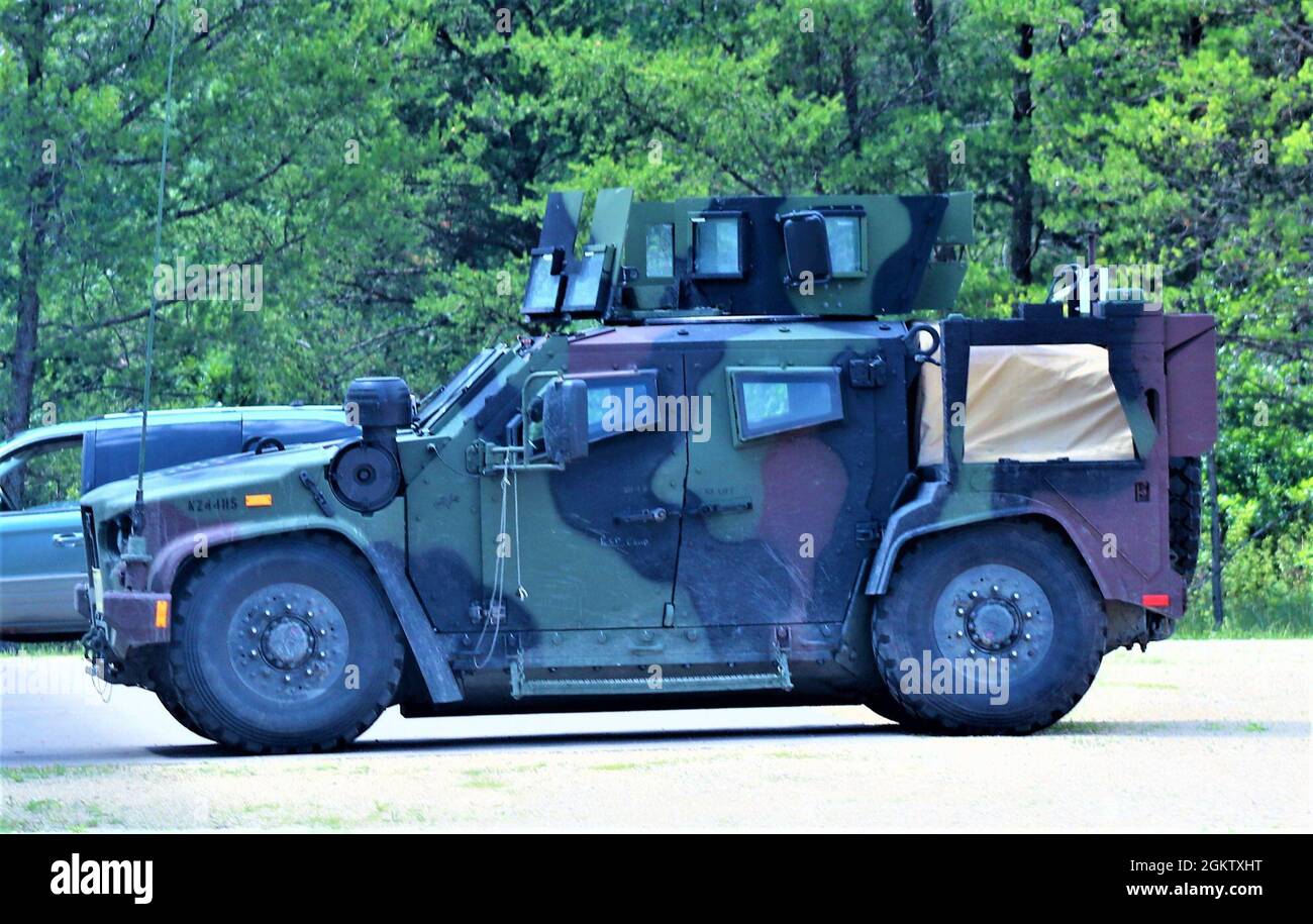 Personnel drive a Joint Light Tactical Vehicle (JLTV) through the ...