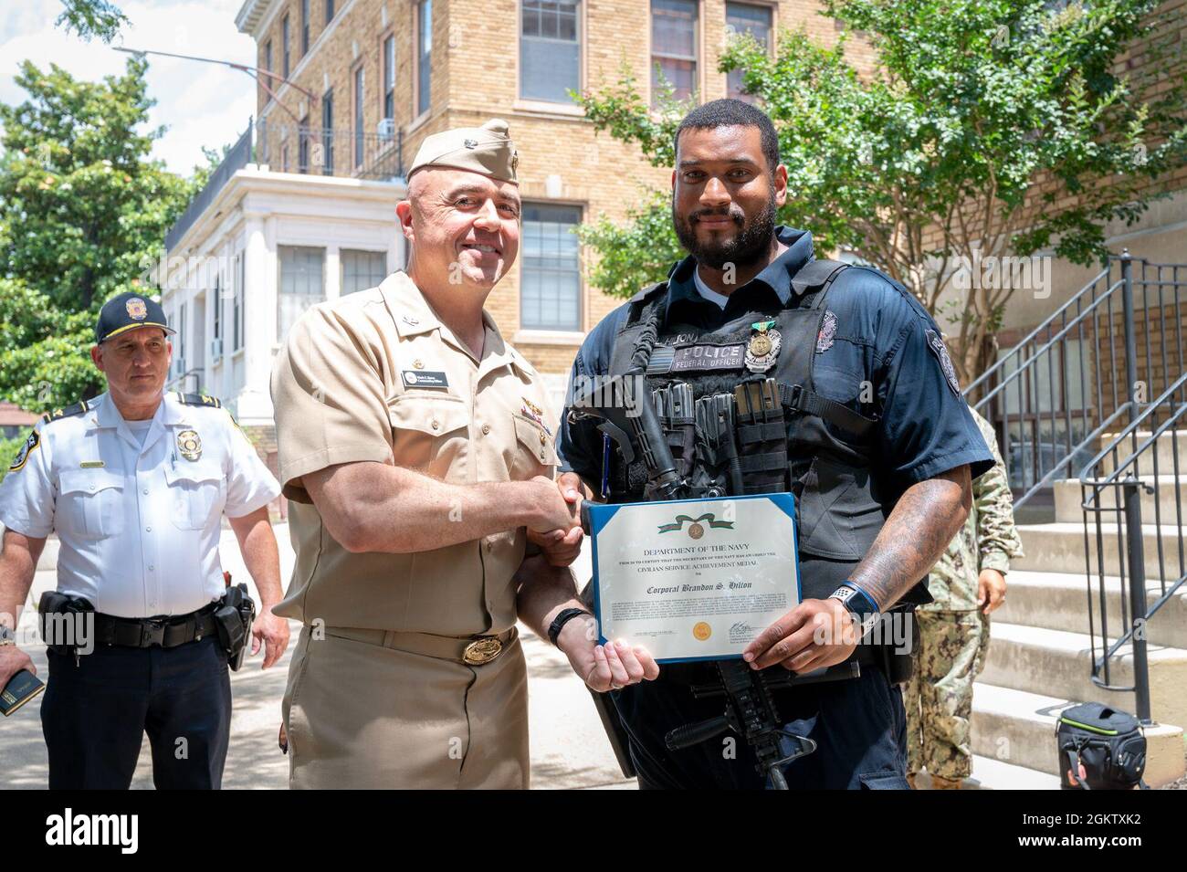 WASHINGTON, DC (July 1, 2021) – Capt. Mark Burns (left), Naval Support ...
