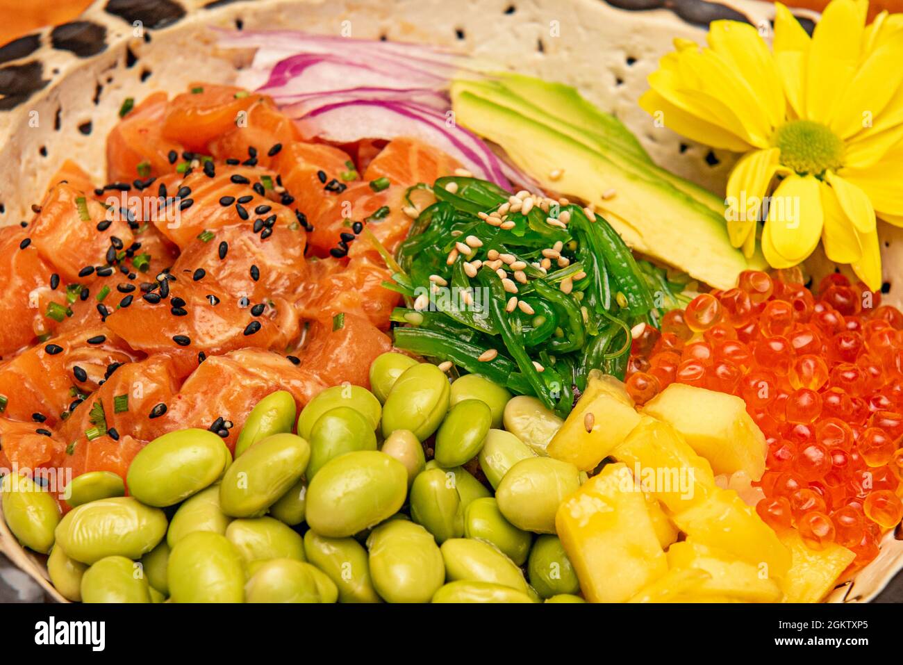 Closeup of ingredients used in salmon poke bowl with green beans, mango ...