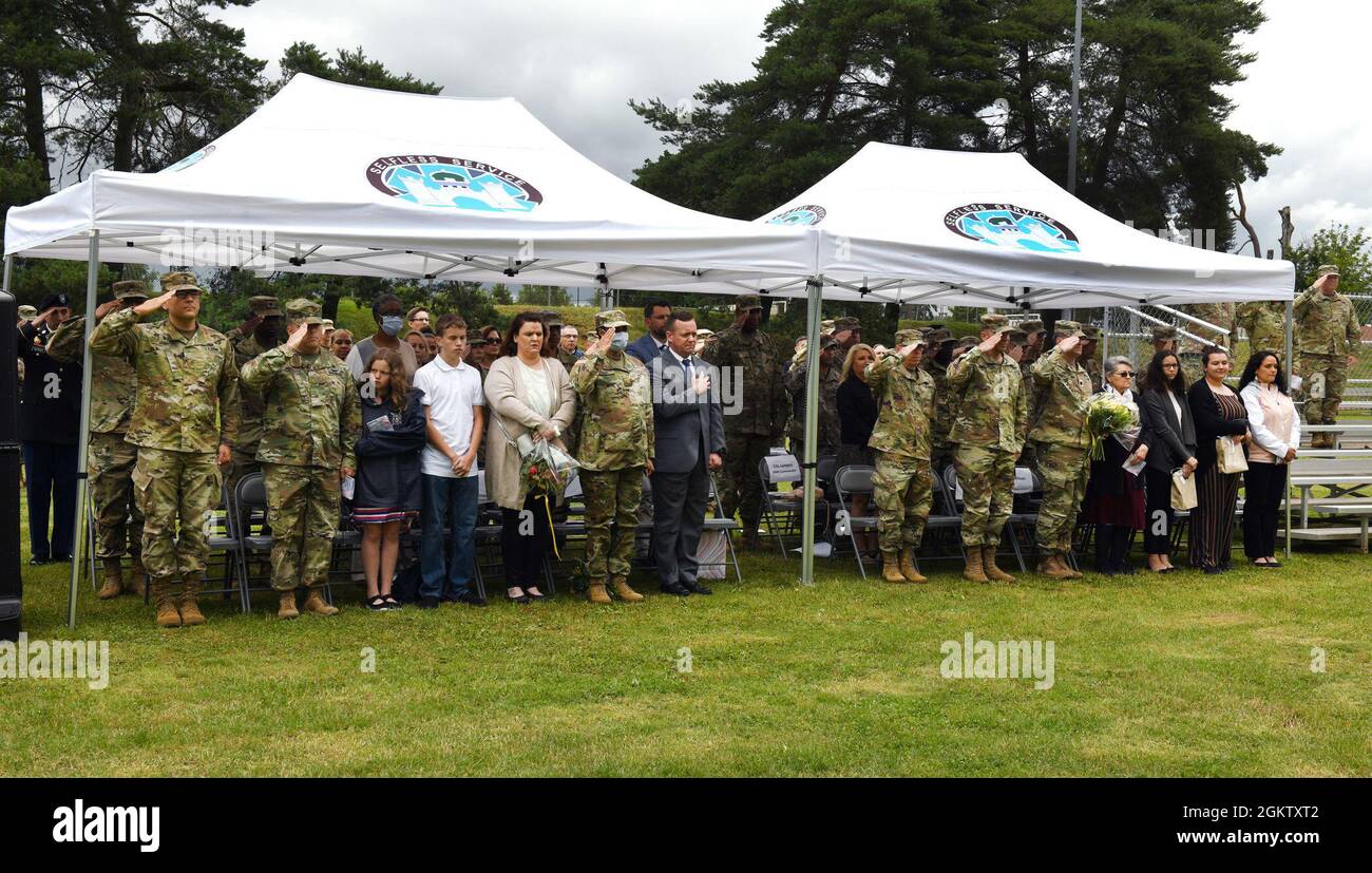U.S. Army Soldiers, family and guests render honors as the U.S. and German national anthems play ...