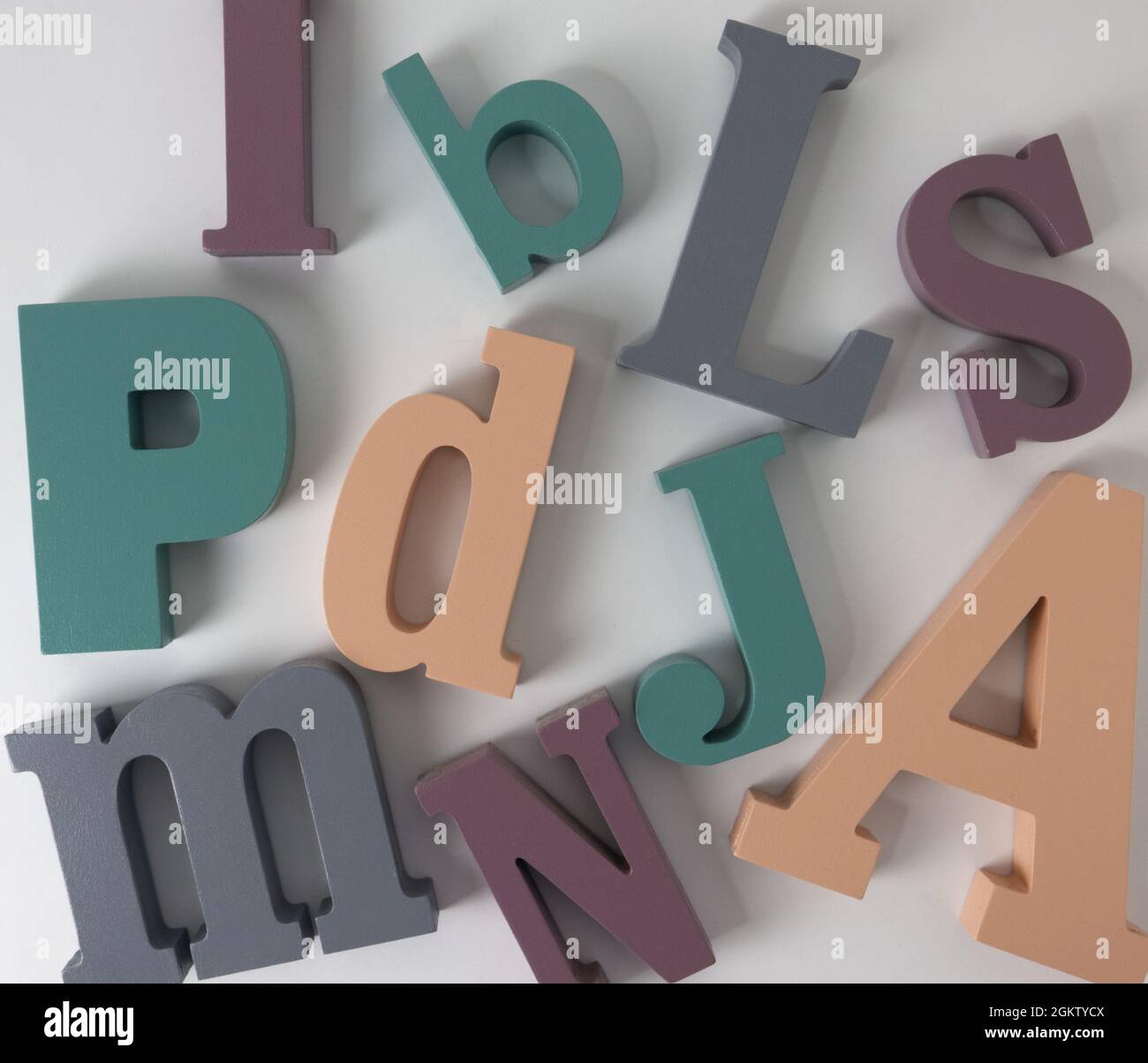 3d wooden letters of different sizes on a white background Stock Photo ...