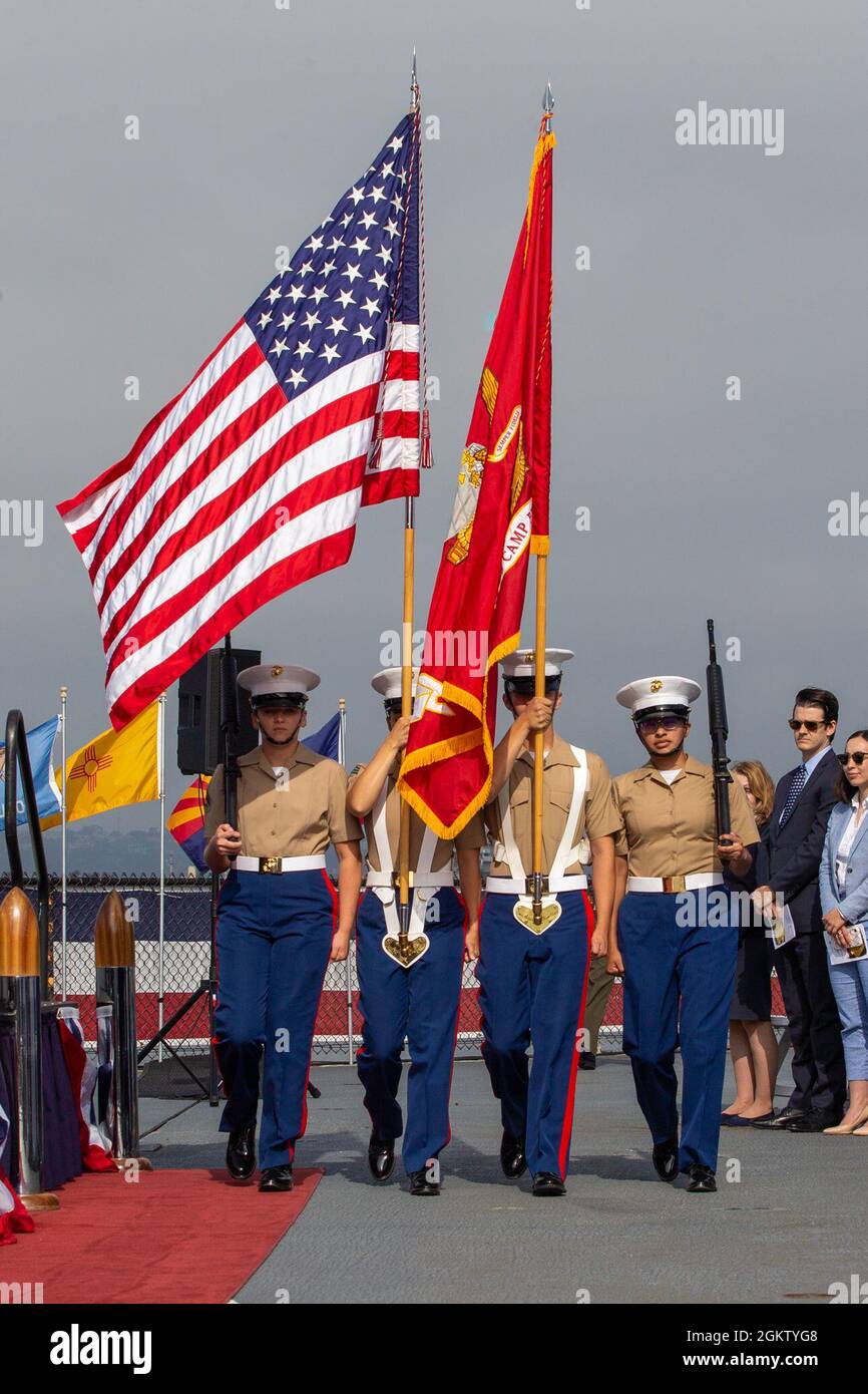 A U.S. Marine color guard marches with the colors during an all ...