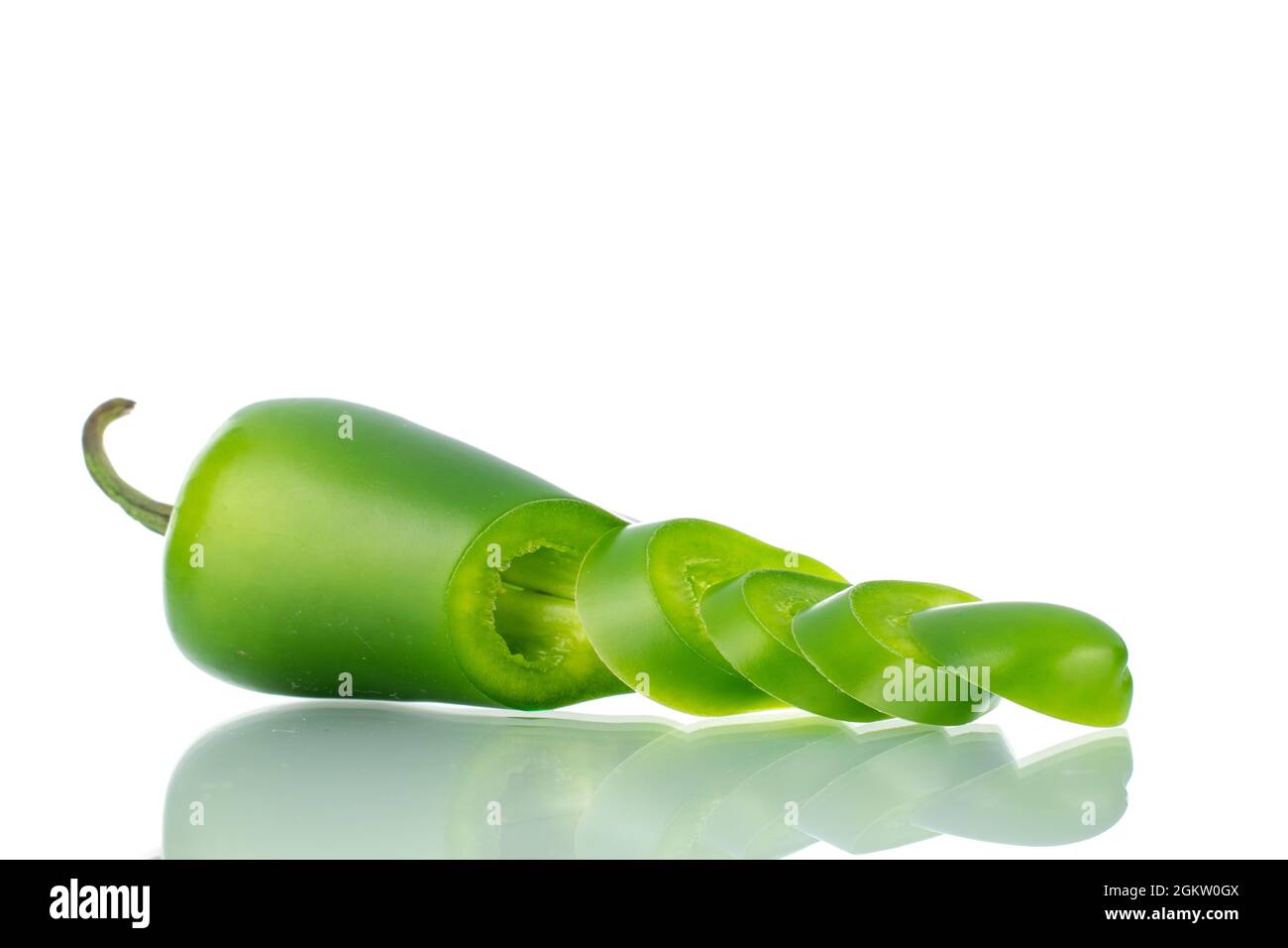 One pod of hot green pepper cut into slices, close-up, isolated on ...