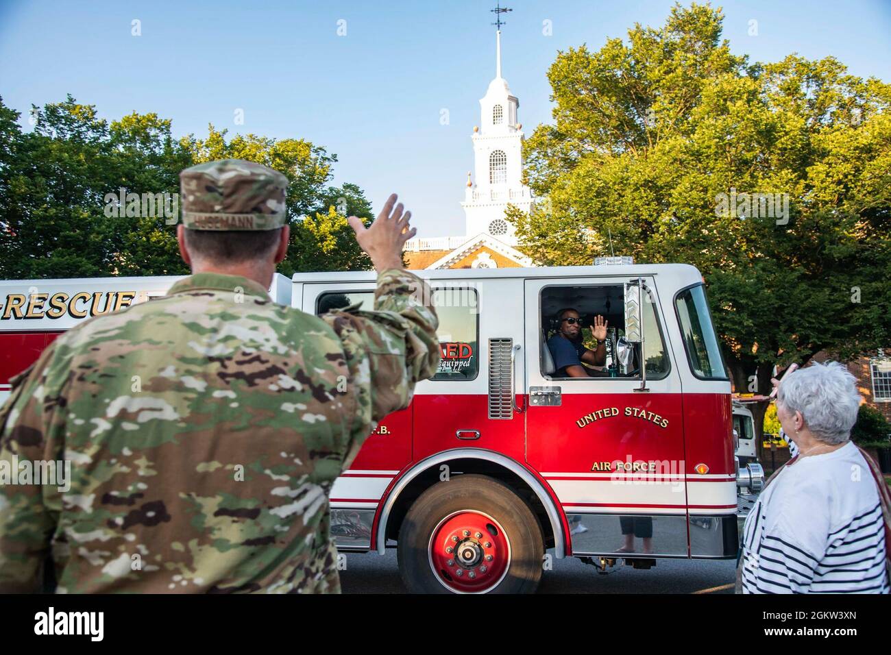 A member of the 436th Civil Engineer Squadron fire department waves to ...