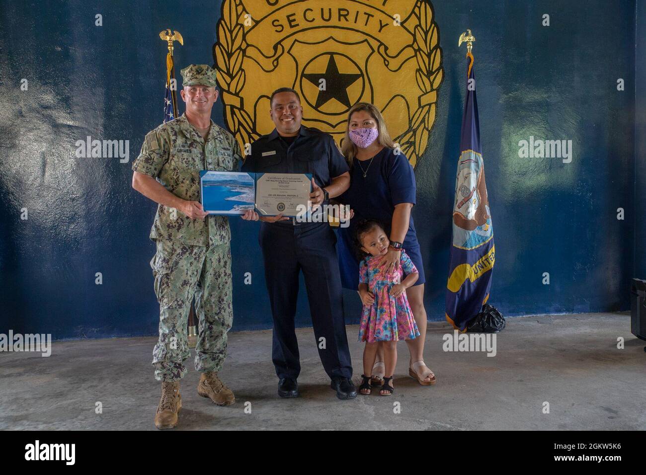 Anton Aguon poses with his family and U.S. Navy Capt. Jeffrey Grimes ...