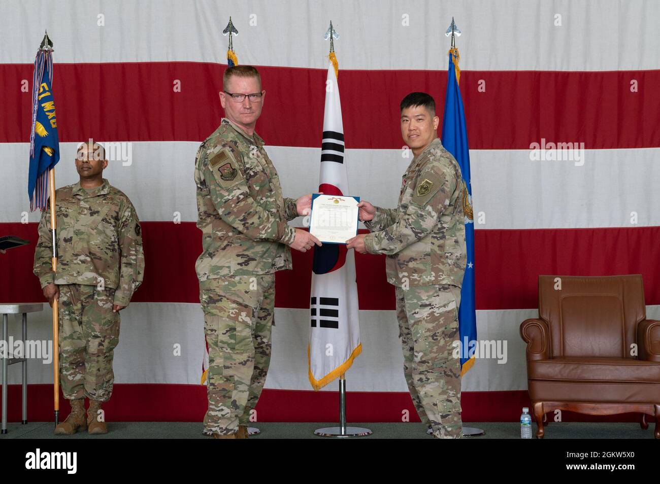 Col. Brian Moore, 51st Maintenance Group commander, left, presents the ...
