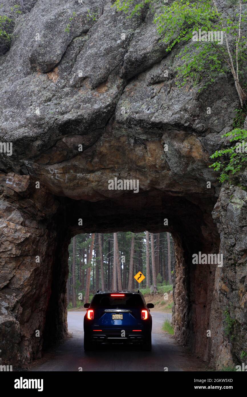 A car driving through Scoval Johnson Tunnel on Needles Highway Scenic ...