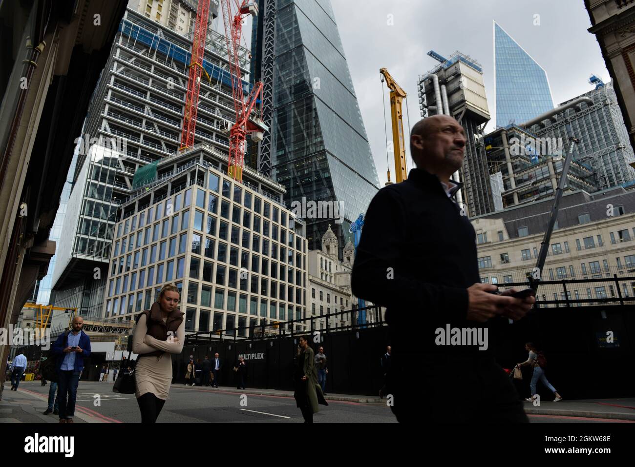 Pedestrians are seen passing by Bishopsgate Street, in the City of ...