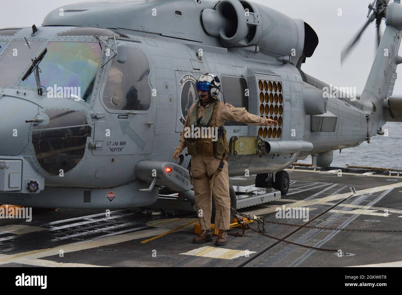 Lt. Hannah Vincent, a native of Columbus, Ohio, uses hand signals to ...