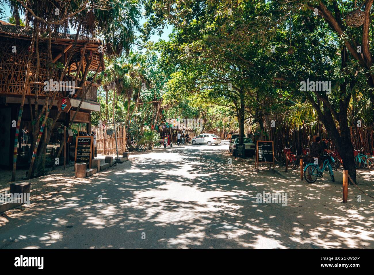 Shops and restaurants at roadside near beach with parked cycles Stock ...