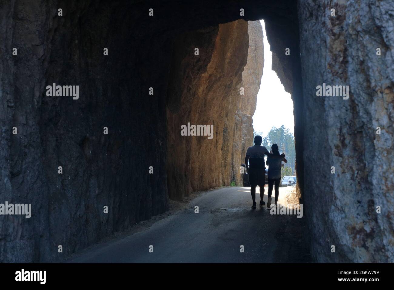 People walking through Needles Eye Tunnel on Needles Highway in Custer ...