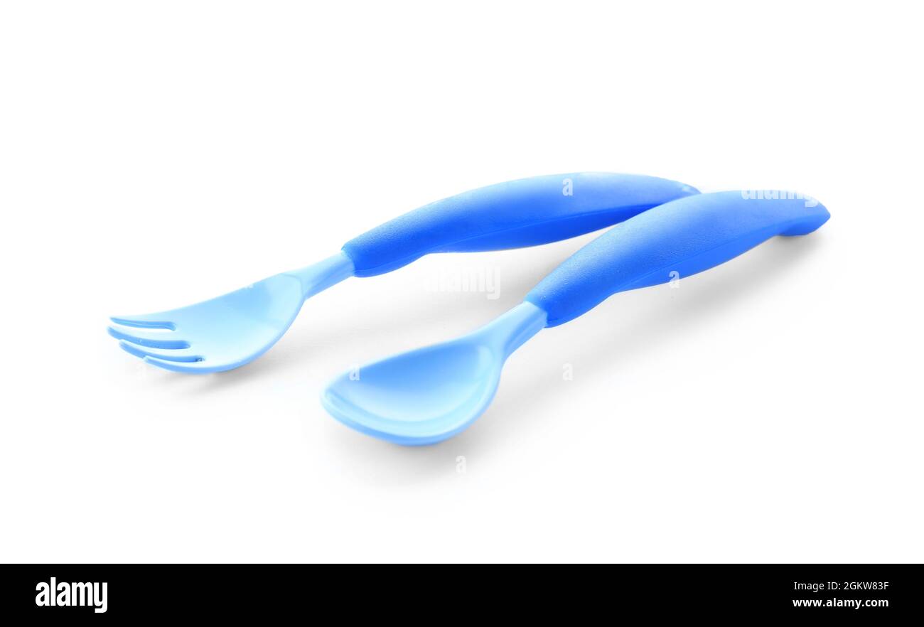 Colorful eating utensils for baby on white background Stock Photo - Alamy