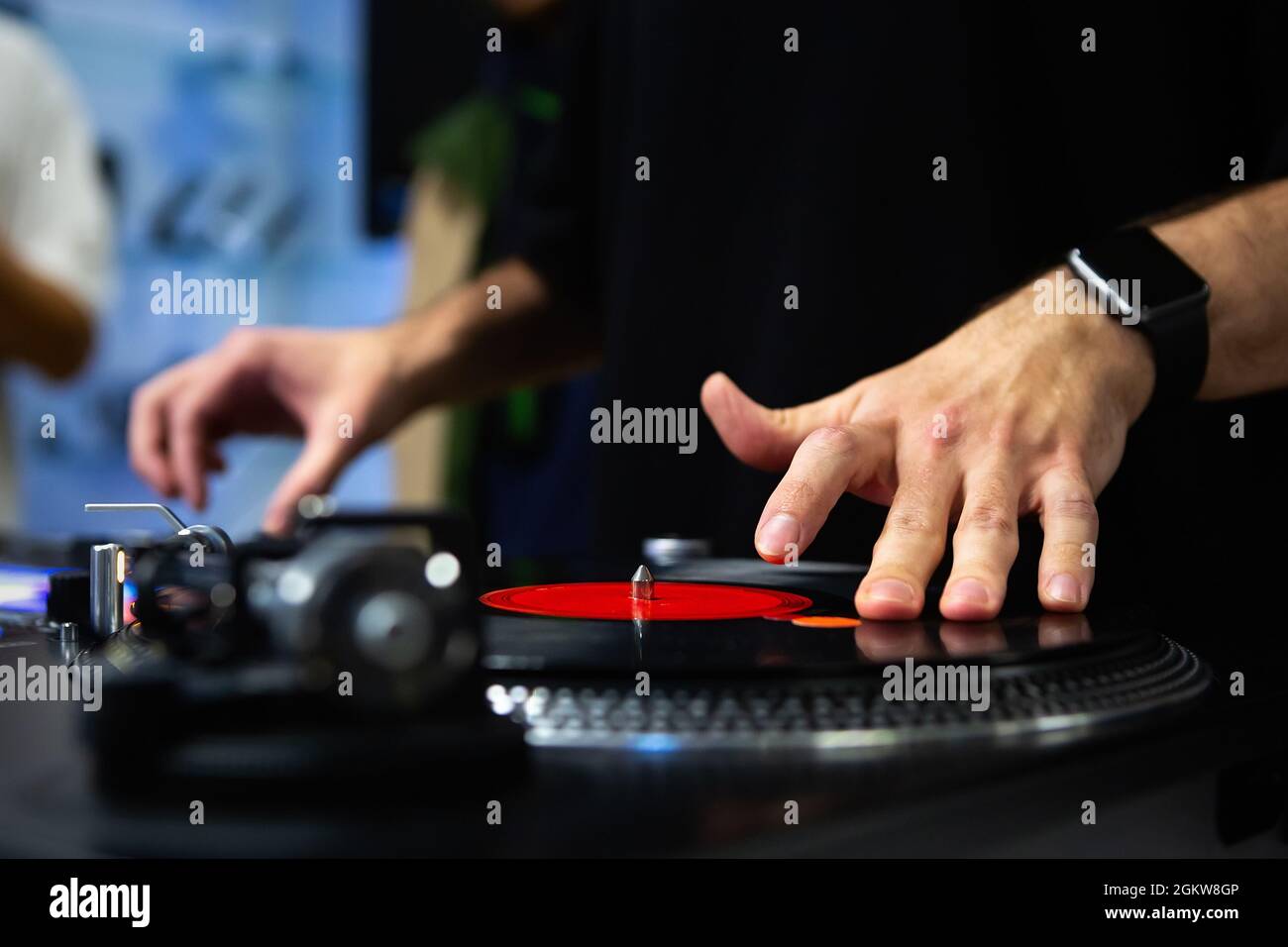 Hip hop dj scratching vinyl records on stage. Professional disc jockey ...