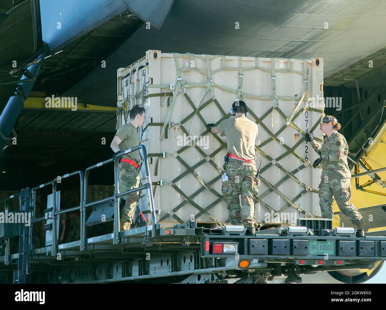Airmen with the 62nd Airlift Wing prepare pallets for loading on a C-5 ...