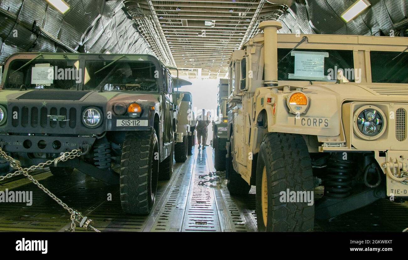 A fleet of military vehicles are loaded onto a C-5 Galaxy for exercise ...