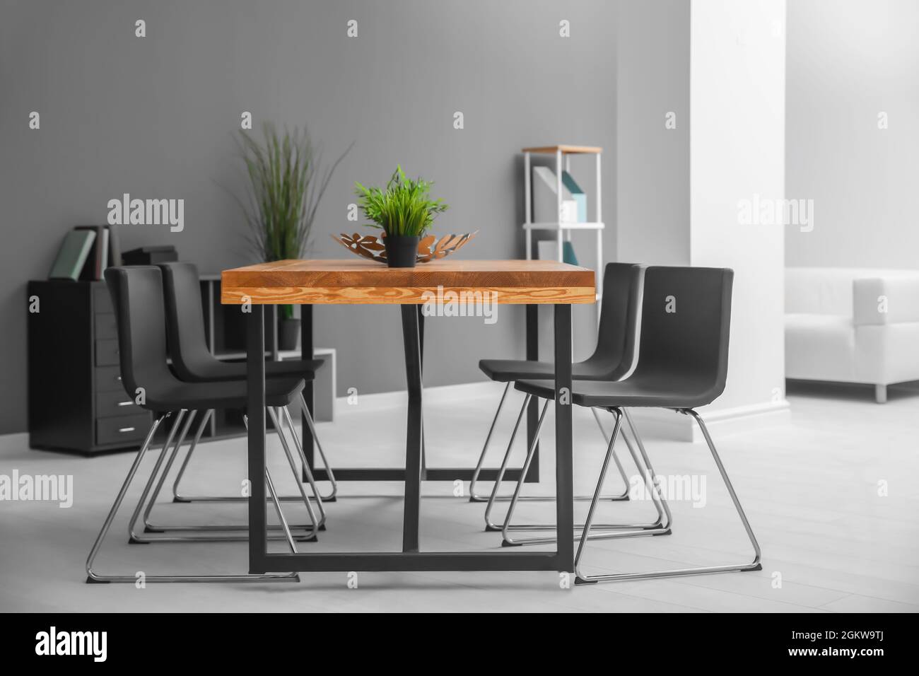 Modern room interior with wooden table Stock Photo - Alamy