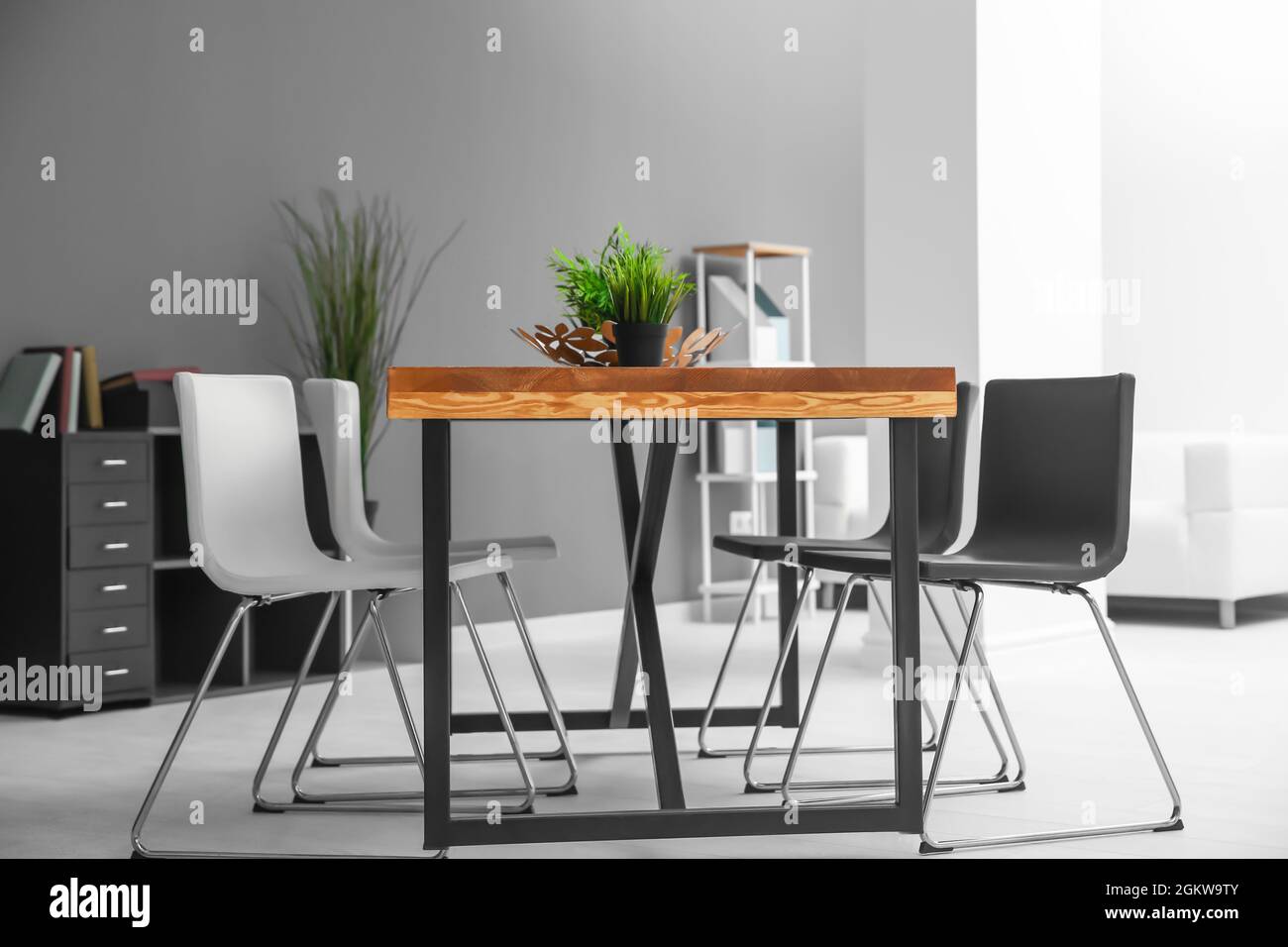 Modern room interior with wooden table Stock Photo - Alamy