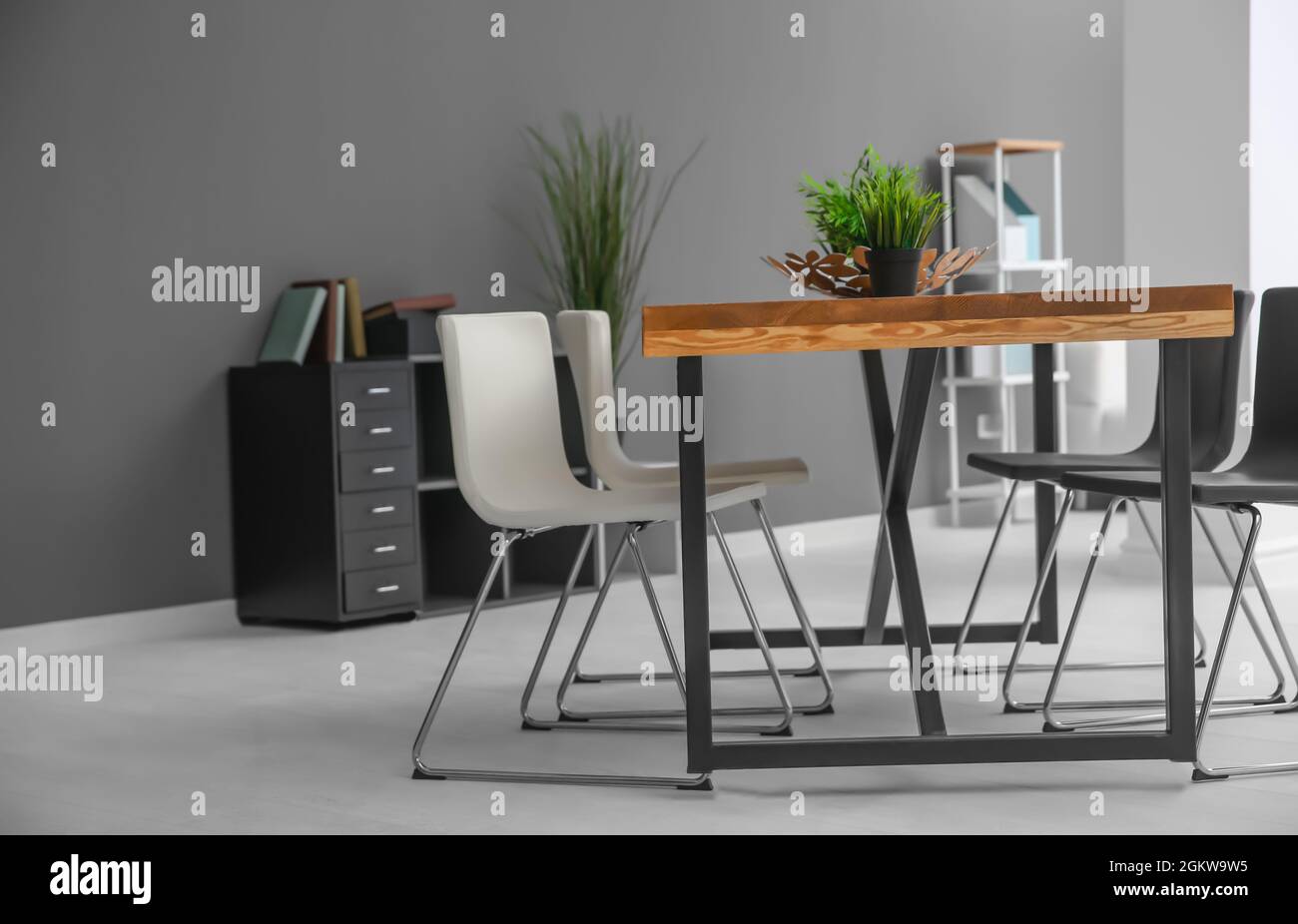 Modern room interior with wooden table Stock Photo - Alamy