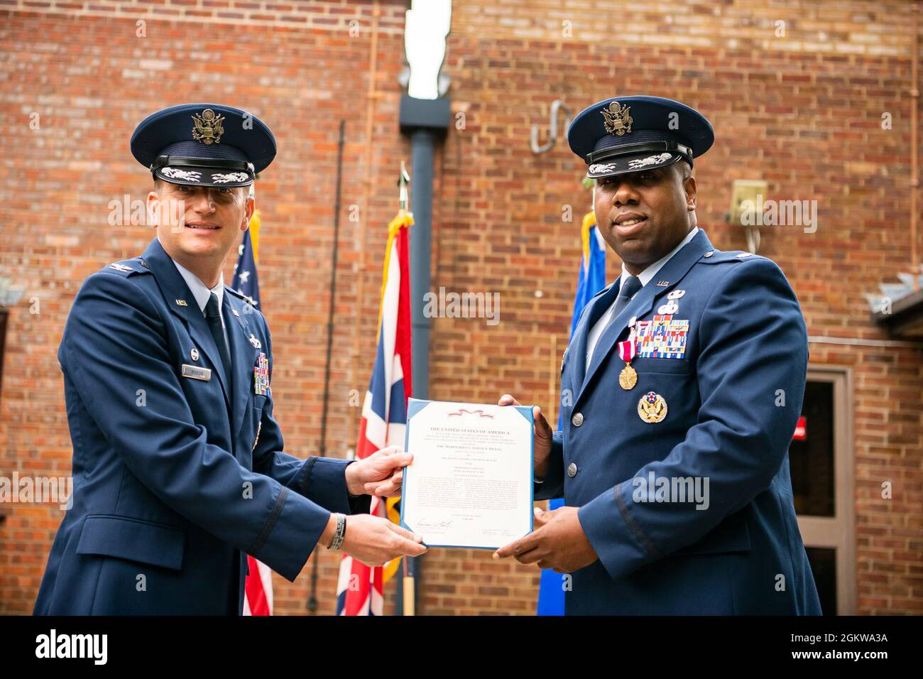 U.S. Air Force Col. Richard Martin, left, 423rd Air Base Group commander, presents a Meritorious ...